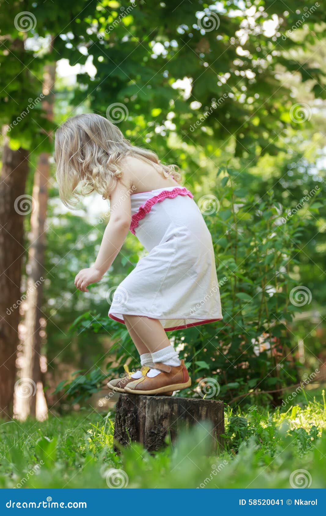 Toddler Girl Jumping Down from Tree Stump Back Stock Image - Image of ...