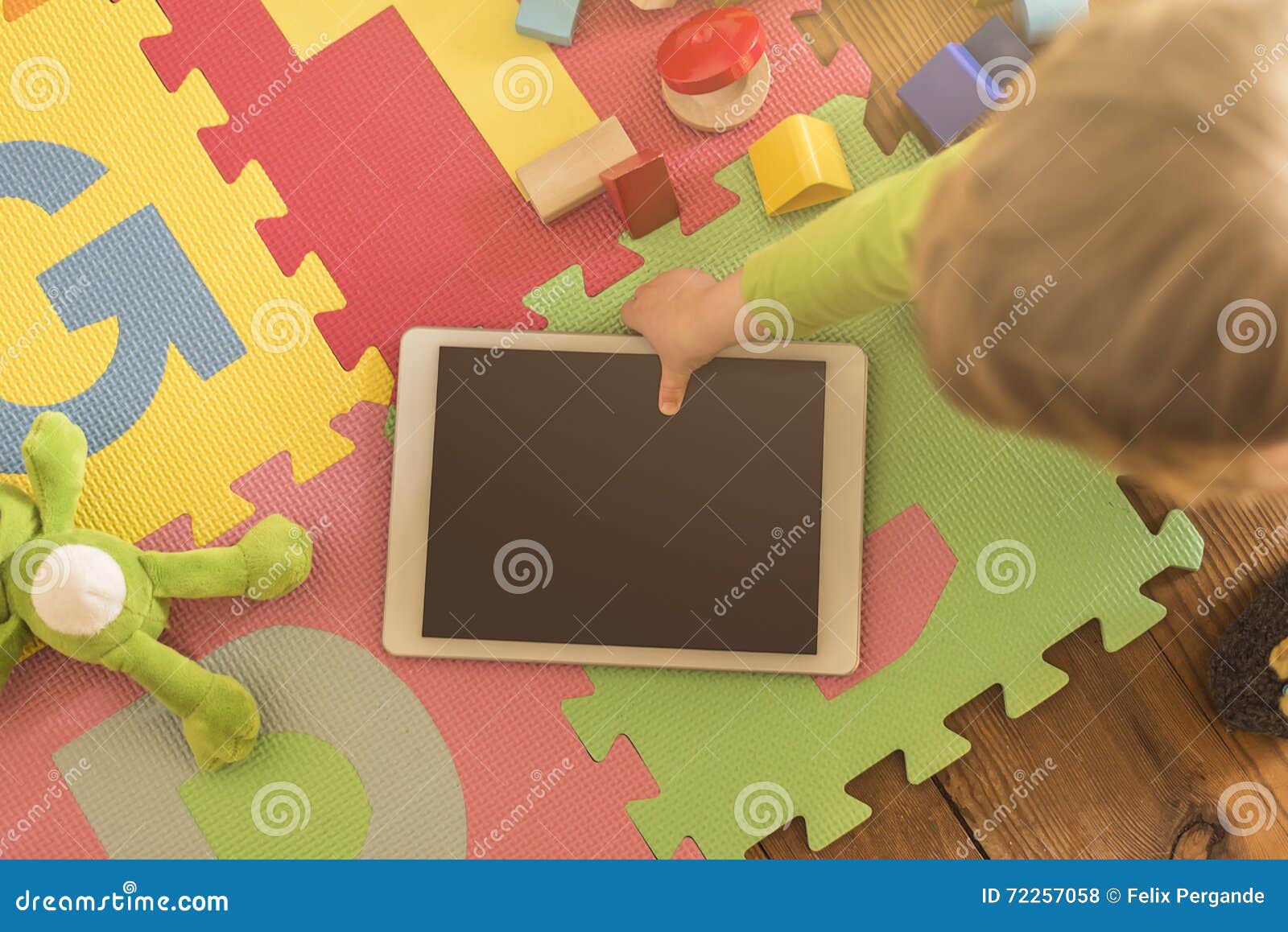 Toddler grabbing tablet stock photo. Image of casual - 72257058