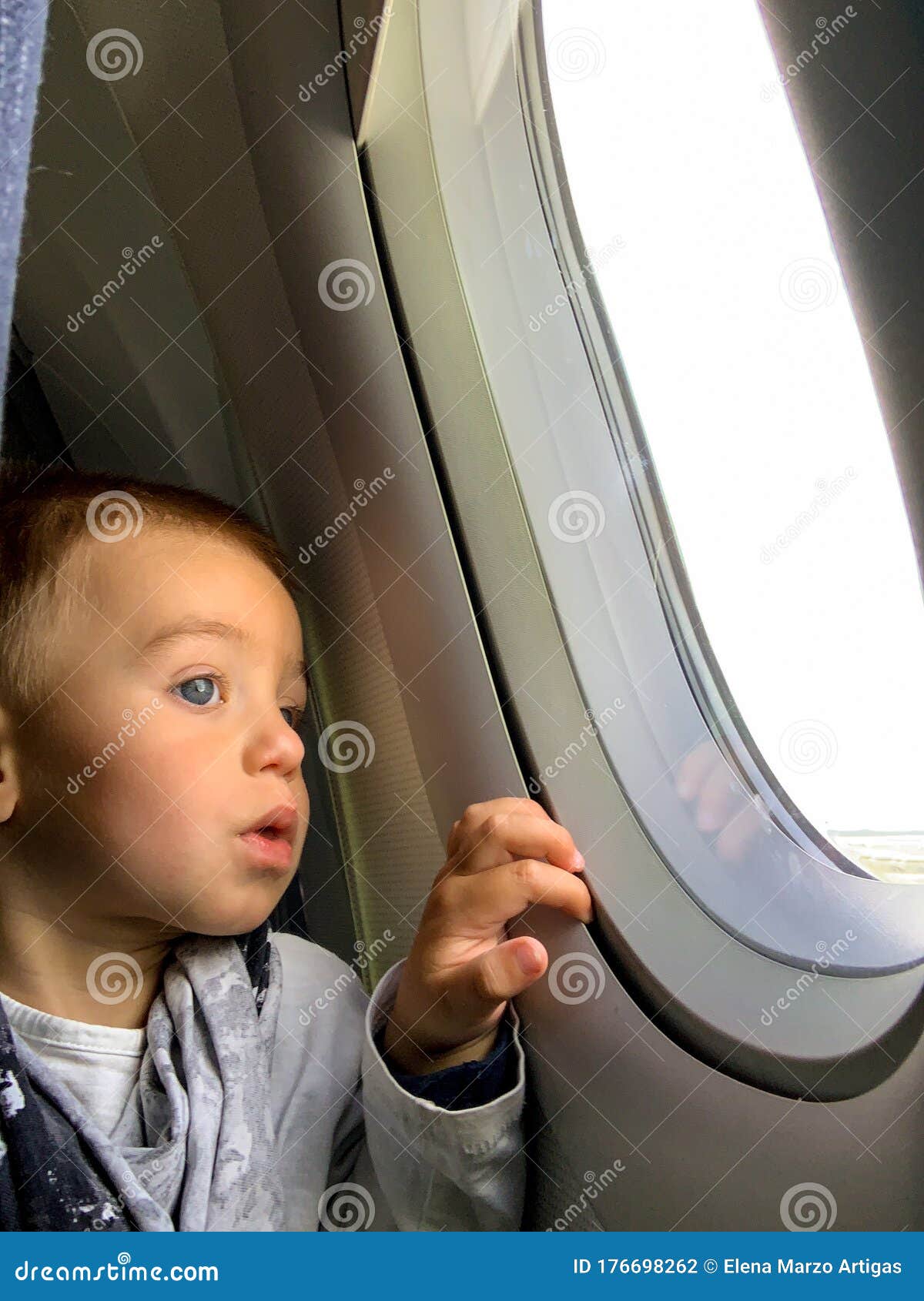 Toddler Looking Out the Window of a Plane Stock Photo - Image of ...