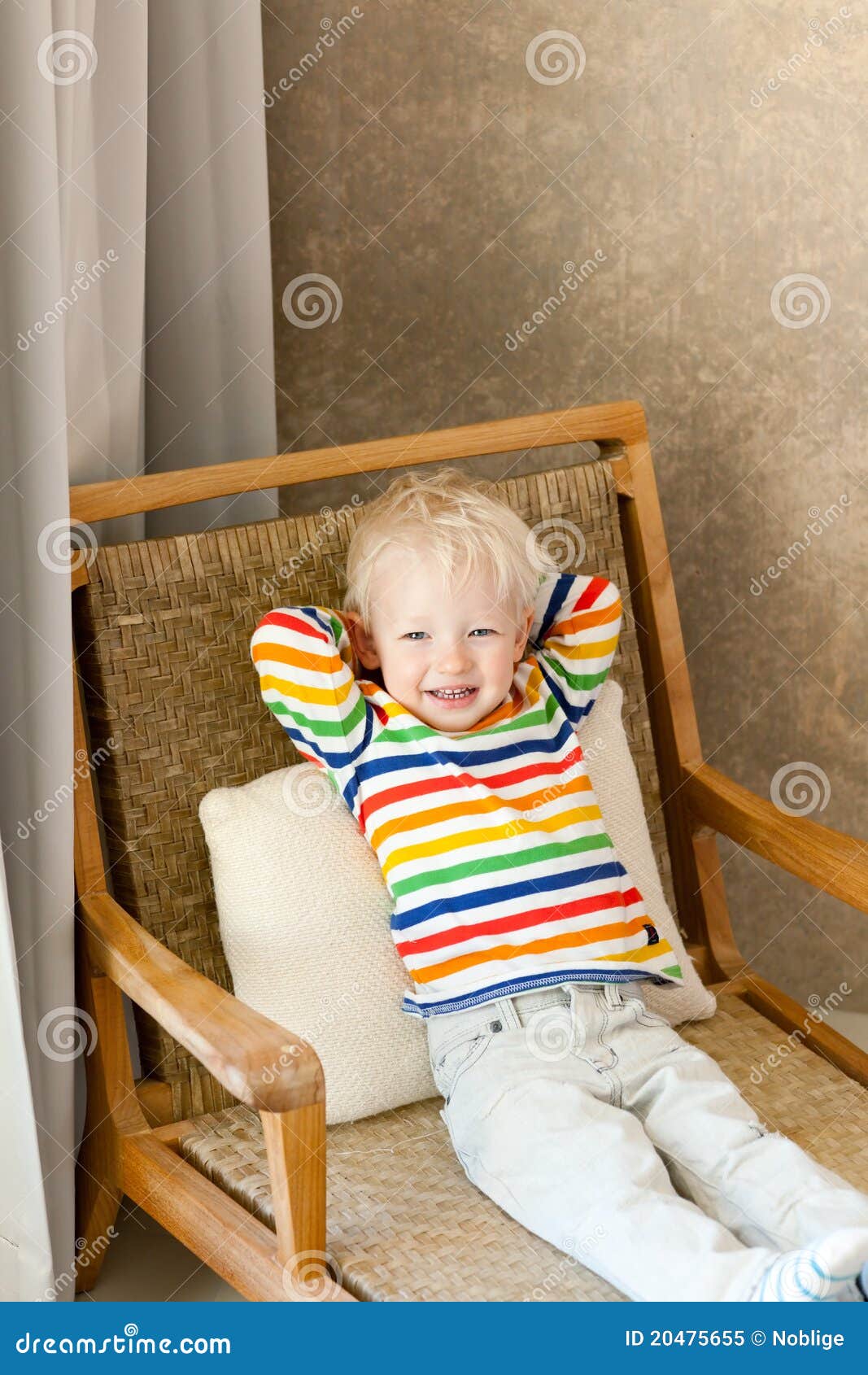 Toddler lying in the chair stock image. Image of innocence - 20475655