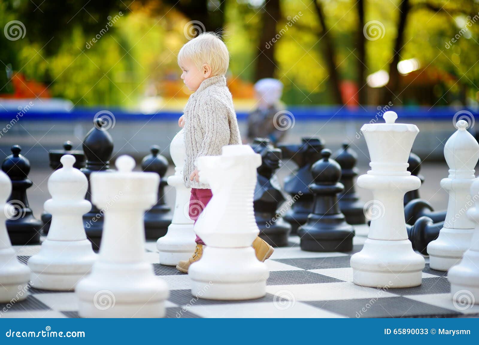 Toddler Playing Giant Chess Outdoors Stock Image - Image of ...