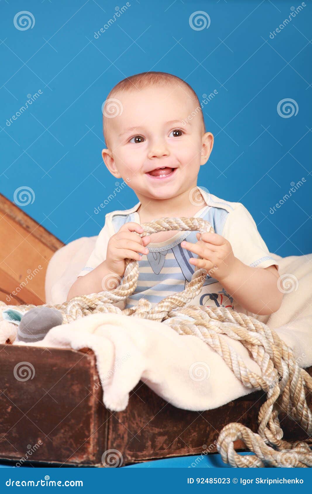 Toddler Playing with a Rope Sitting on a Blue Background Stock Image ...