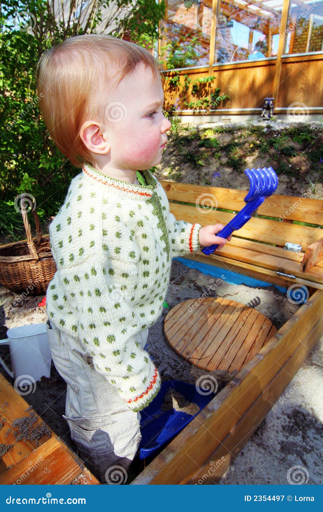 Toddler playing in sandbox stock image. Image of plays - 2354497