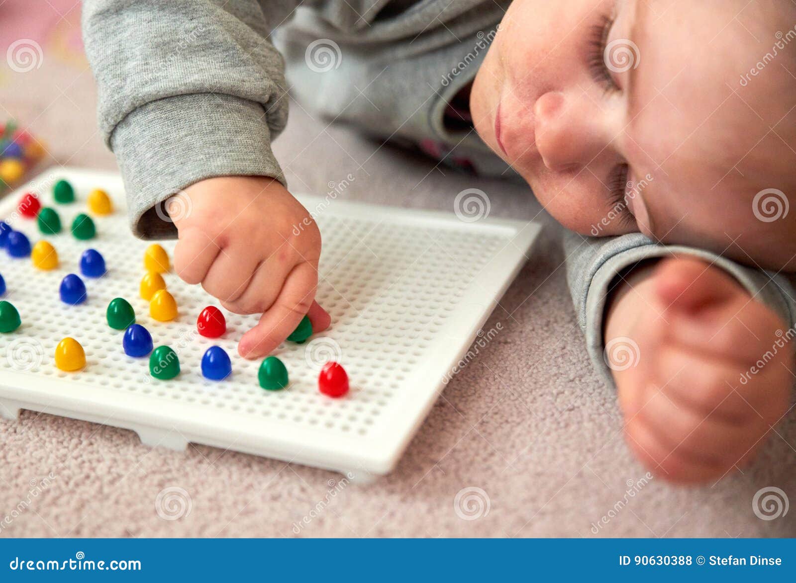 Toddler plays with pins stock photo. Image of develop - 90630388