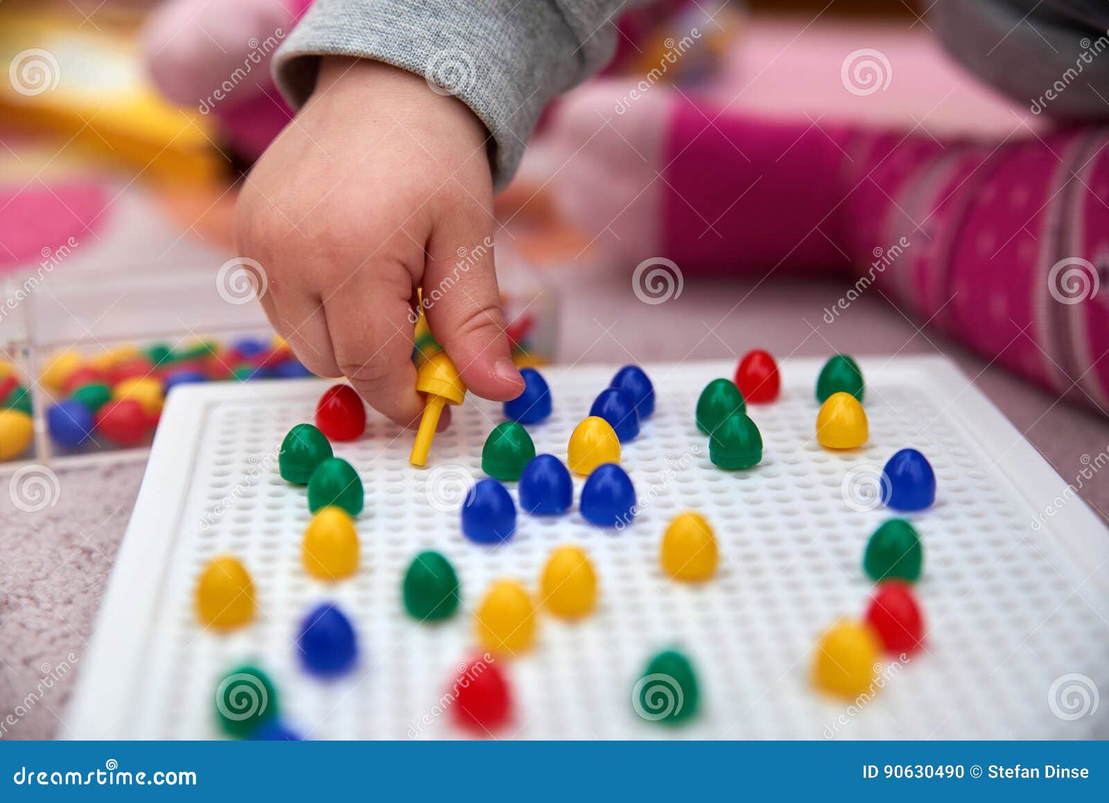Toddler plays with pins stock photo. Image of inside - 90630490