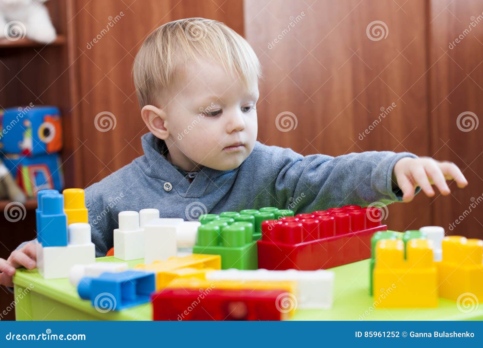 Toddler Reaching for a Toy Constuctor Indoor Stock Photo - Image of ...