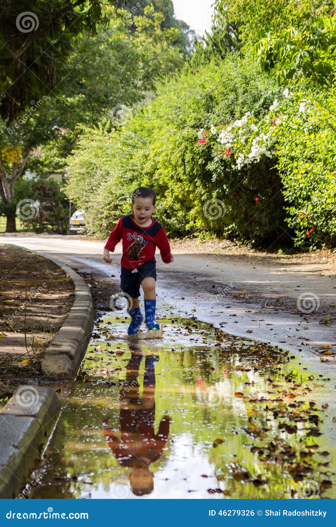 Toddler Running in a Puddle with His New Boots Stock Photo - Image of ...