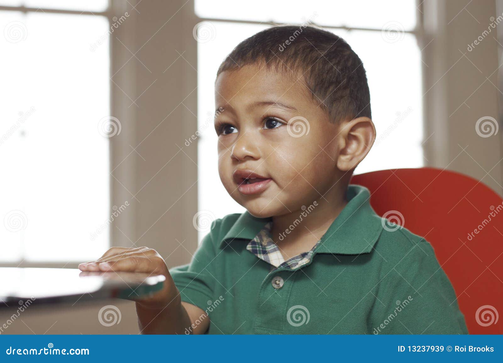Toddler sitting at a table stock image. Image of smile - 13237939