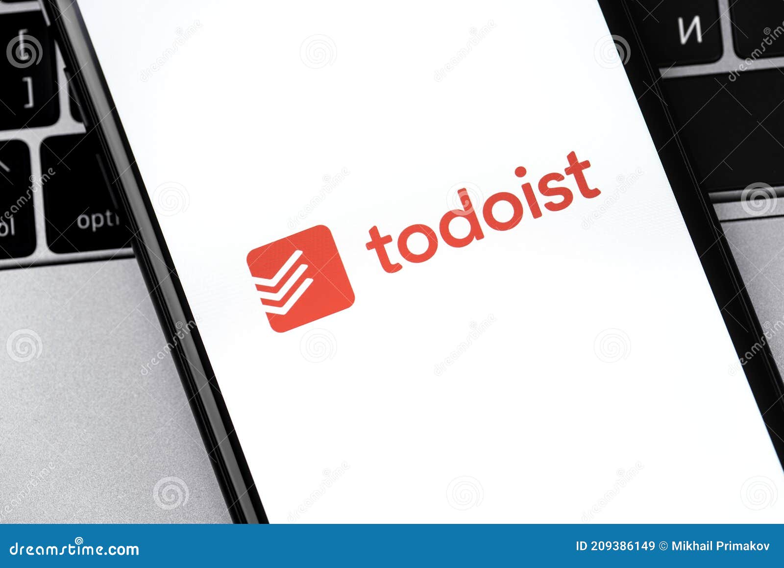 Todoist Logo Mobile App on the Screen Smartphone with Notebook Closeup ...