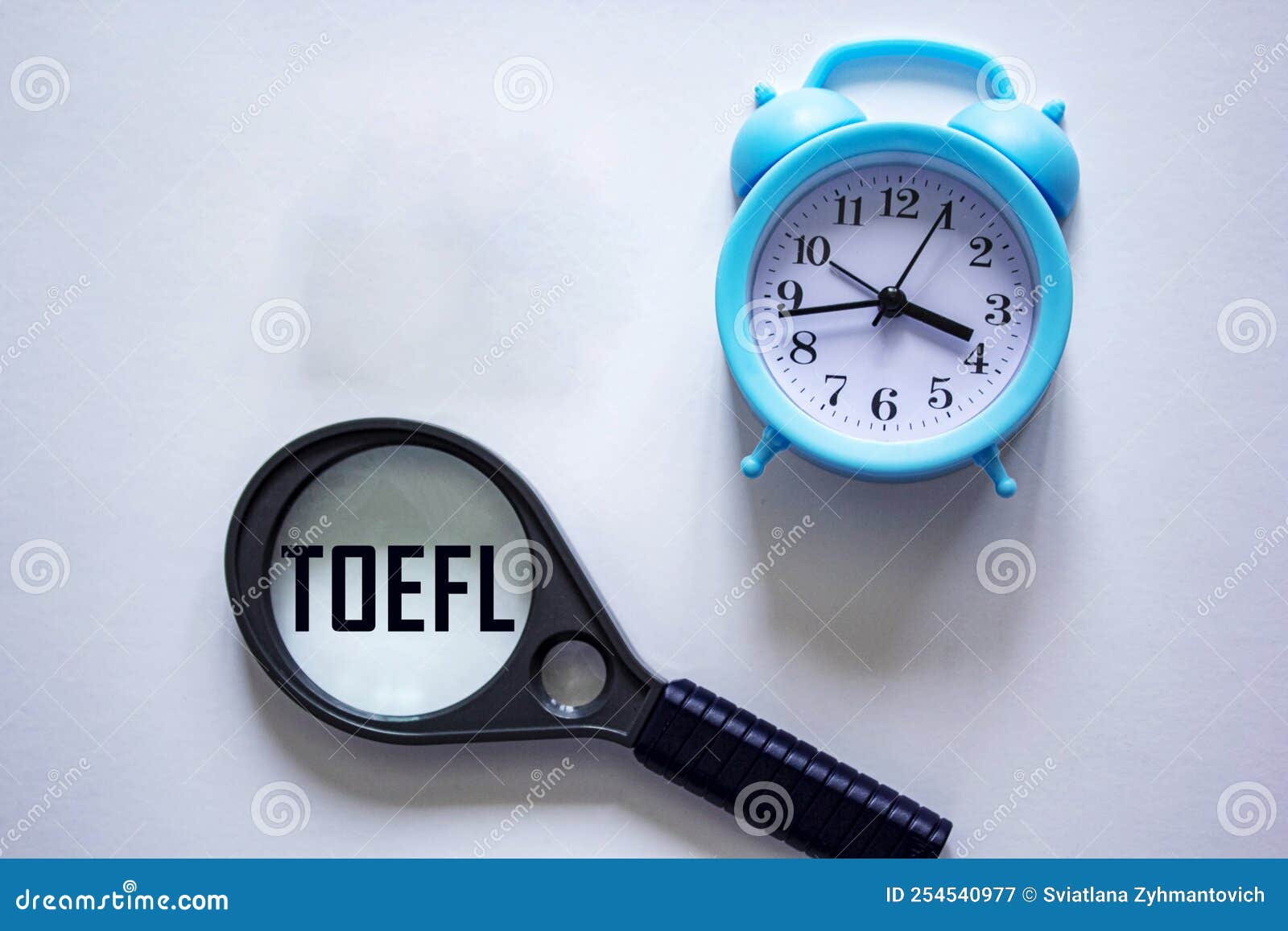 TOEFL is a Test of English As a Foreign Language. Text on a Magnifying ...