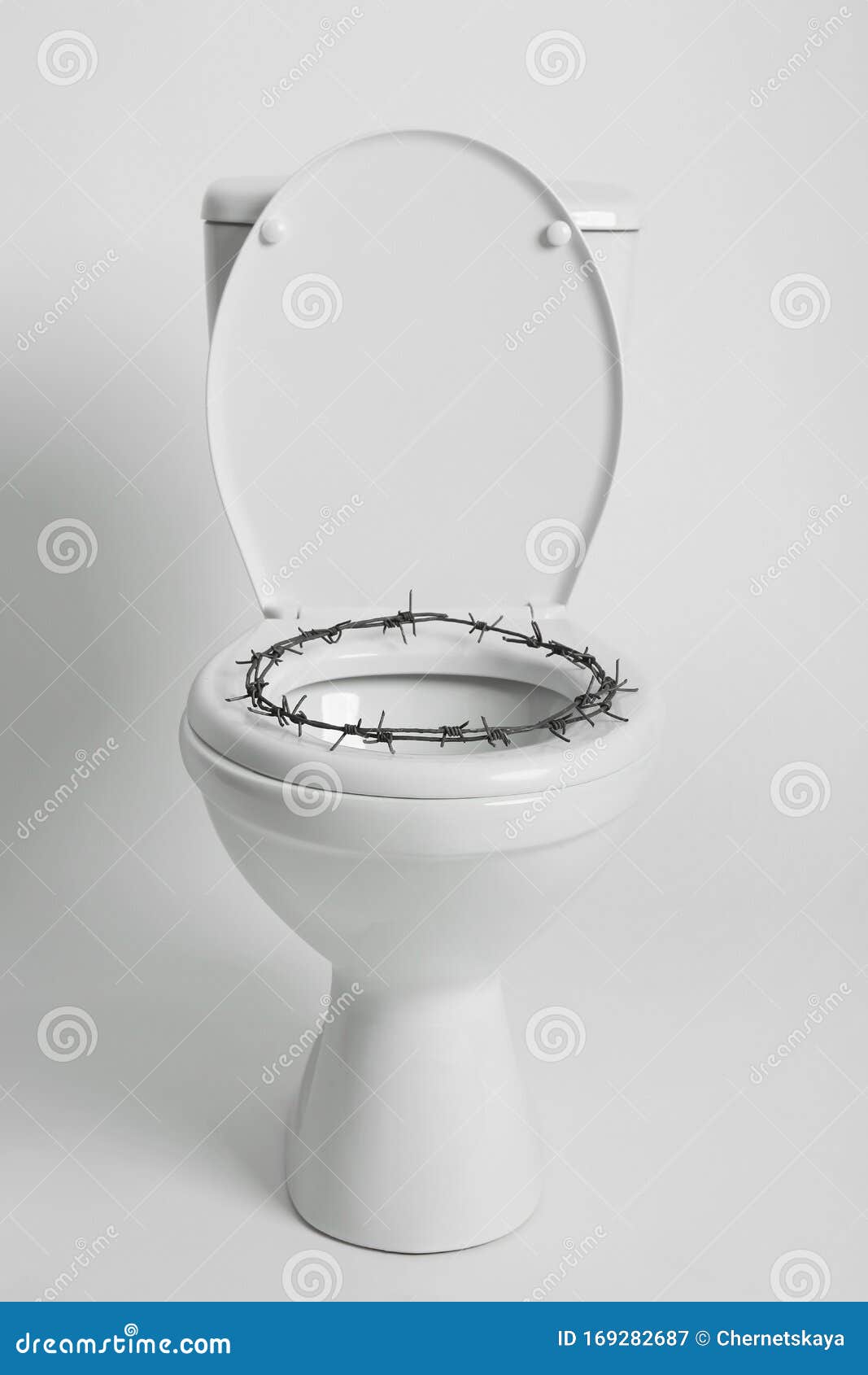 Toilet Bowl With Barbed Wire On Background Hemorrhoids Concept Stock