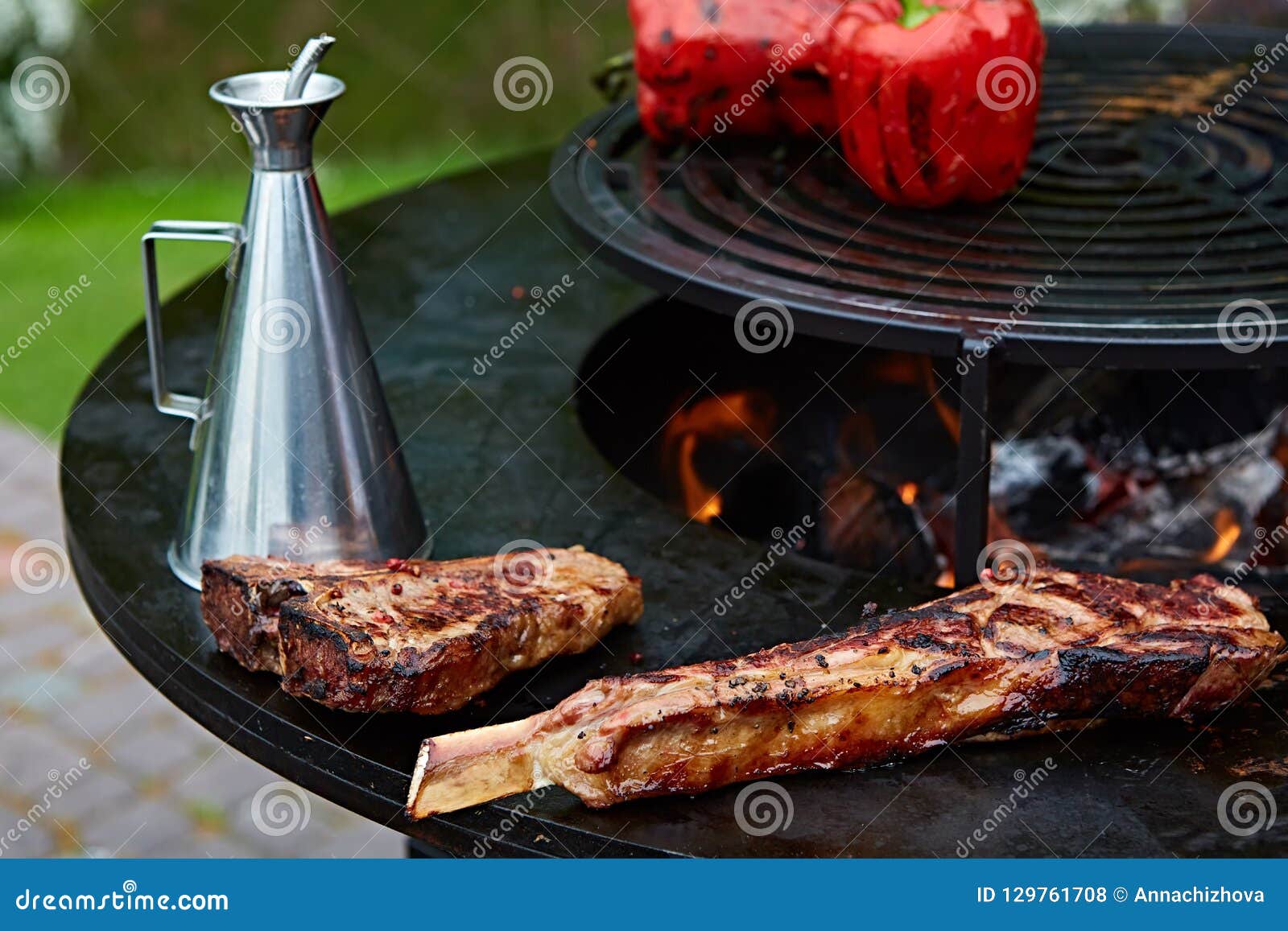 Tomahawk Rib Beef Steak and T-bone on Hot Black Grill. Stock Photo ...