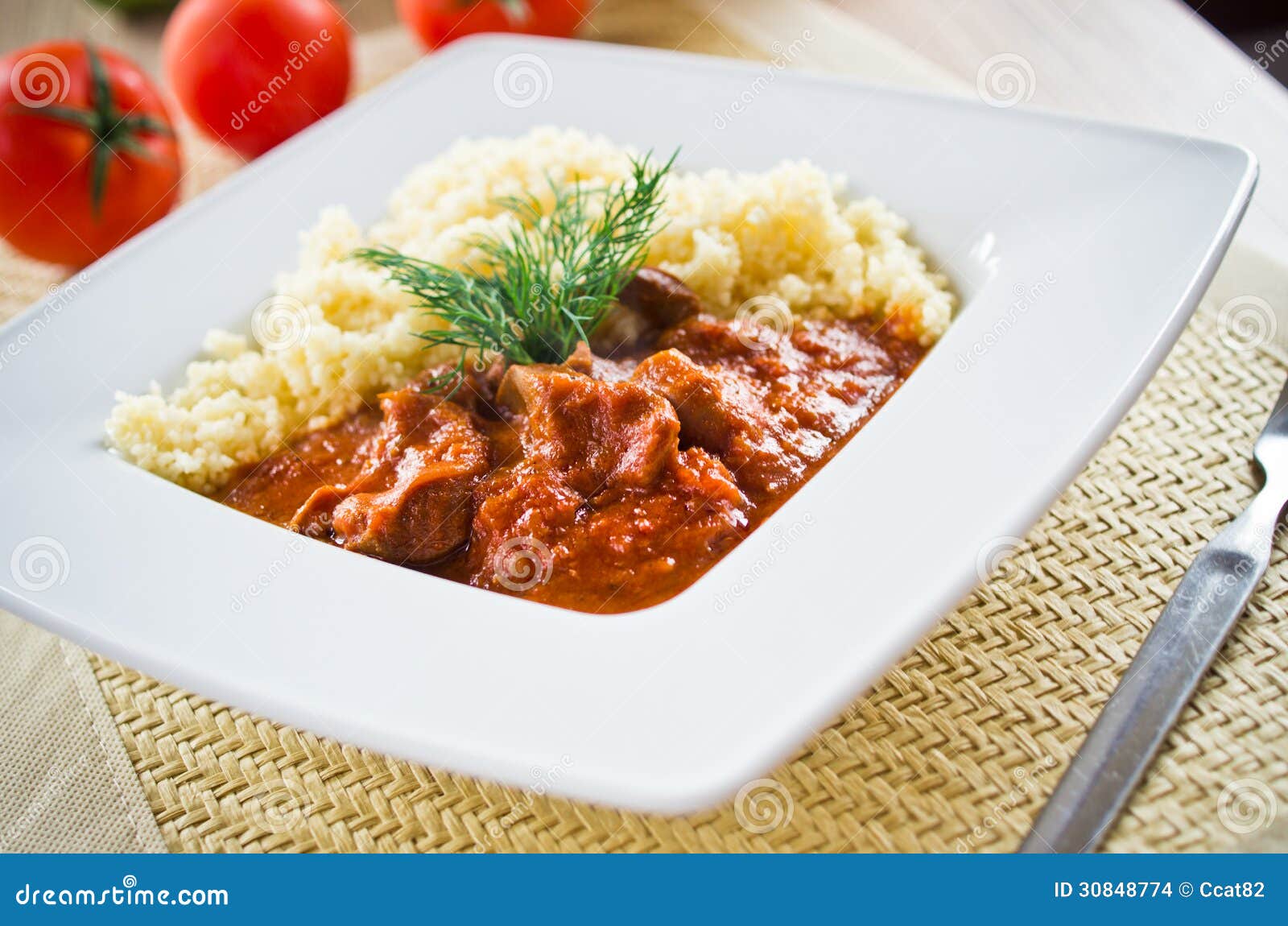Tomato curry with couscous stock photo. Image of food - 30848774