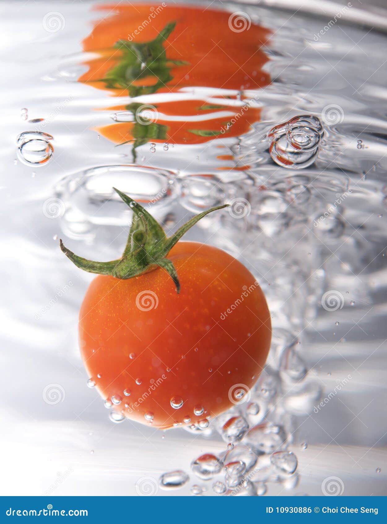 Tomato drop in water stock photo. Image of reflection - 10930886