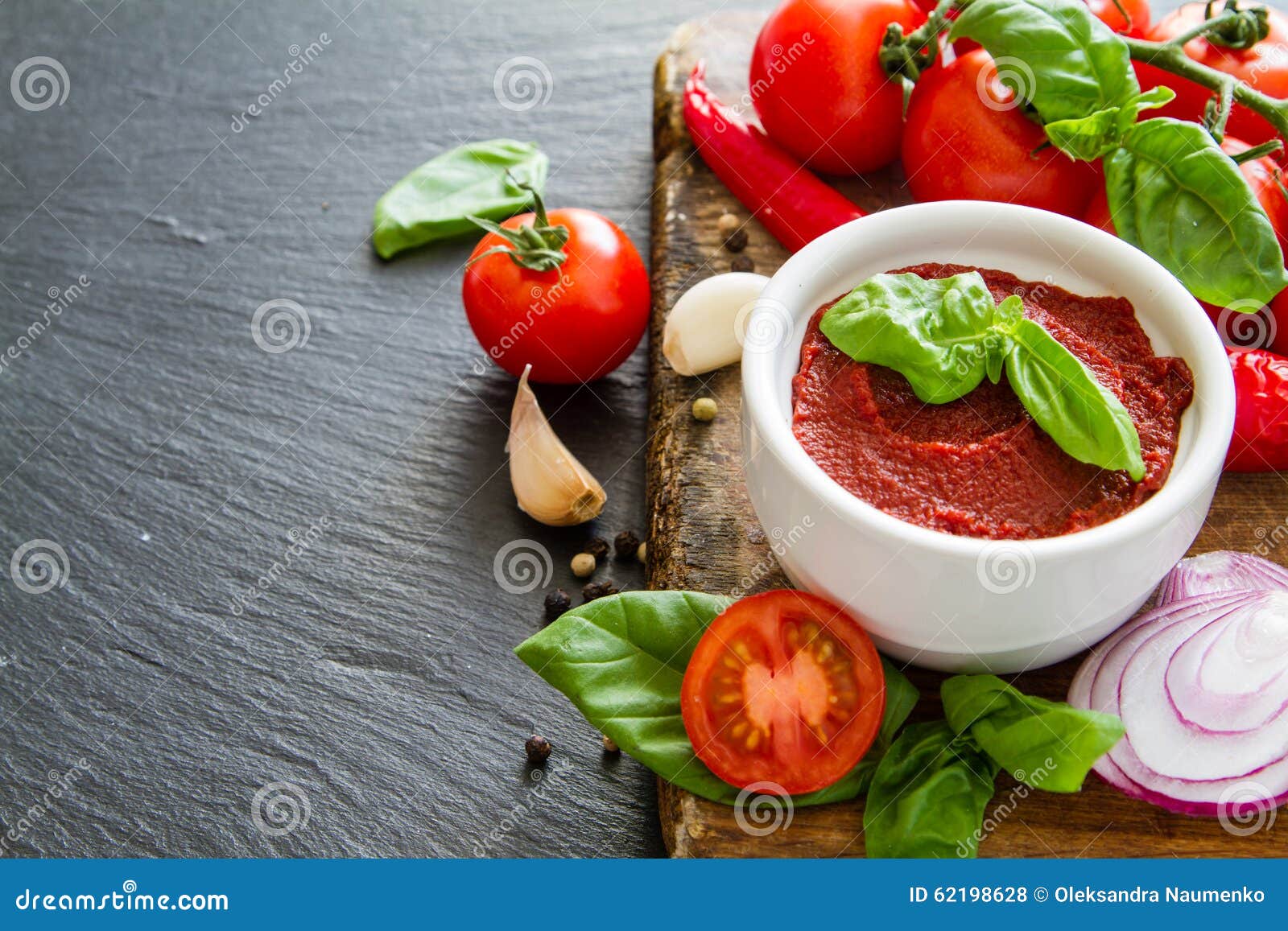 Tomato Sauce and Ingredients on Dark Stone Background Stock Photo ...