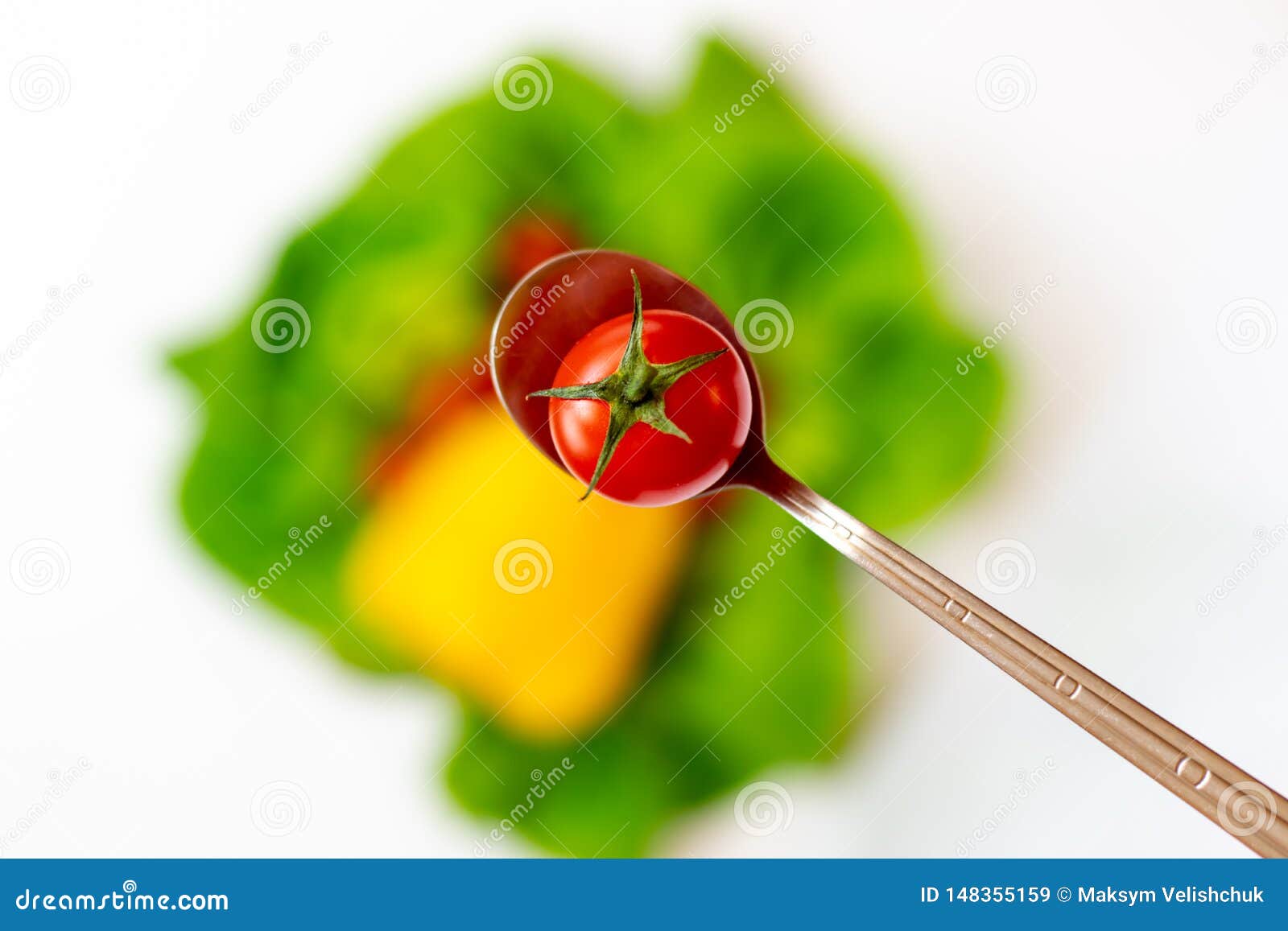 Tomato in a Spoon on a Background of Blurred Colorful Vegetables. Stock ...