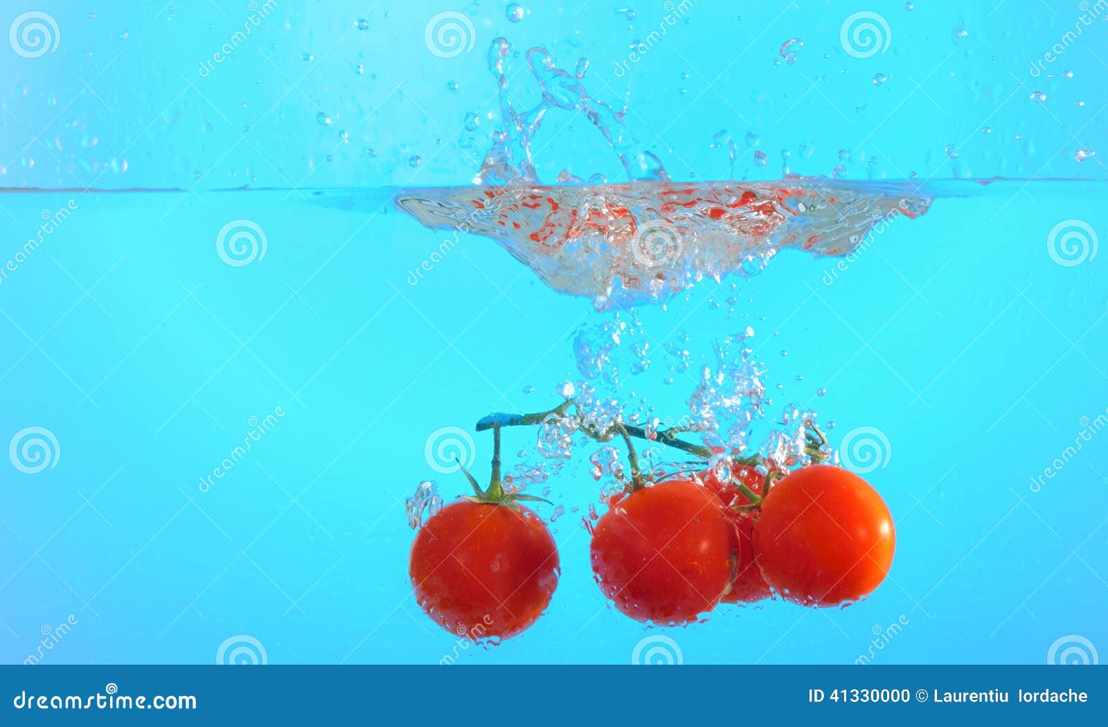 Tomatoes thrown in water stock photo. Image of action - 41330000