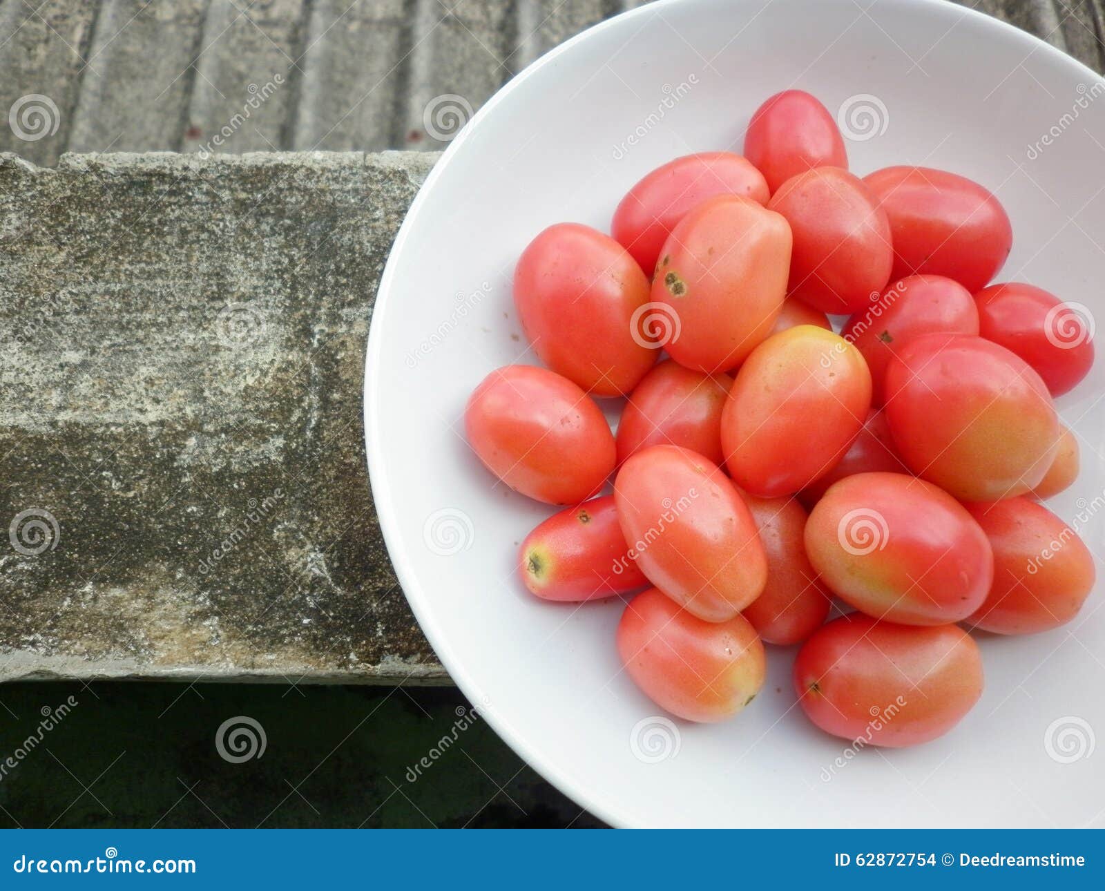 Tometo on white dish stock photo. Image of healthy, fruit - 62872754