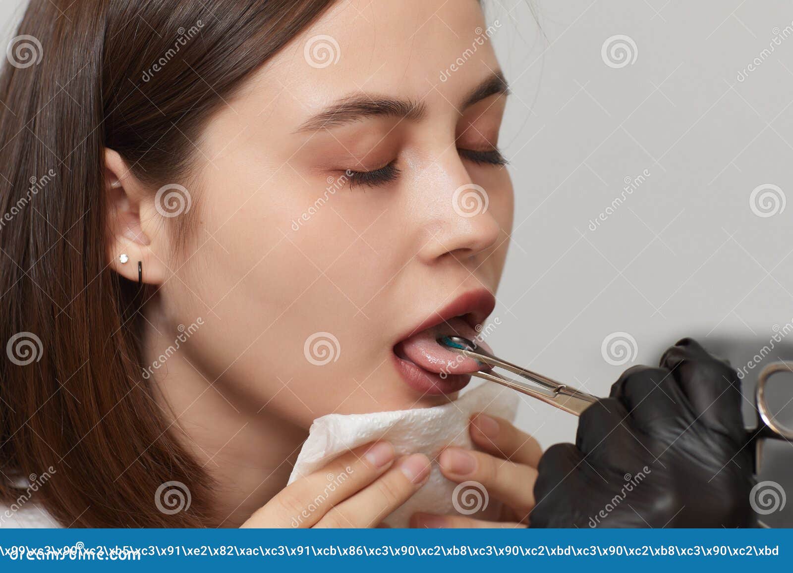 Tongue Piercing Operation Professional Holding the Jewel. Stock Image ...