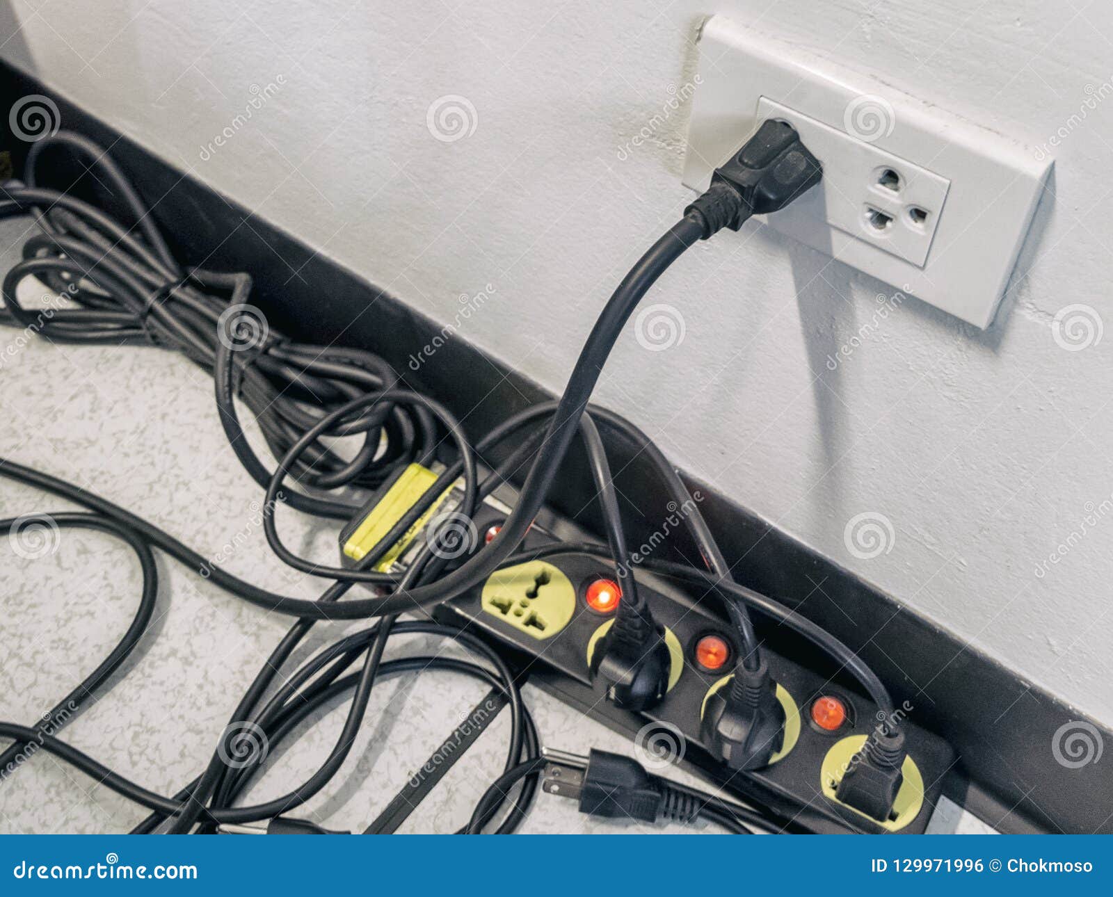 Too many plugs in a socket stock photo. Image of power - 129971996