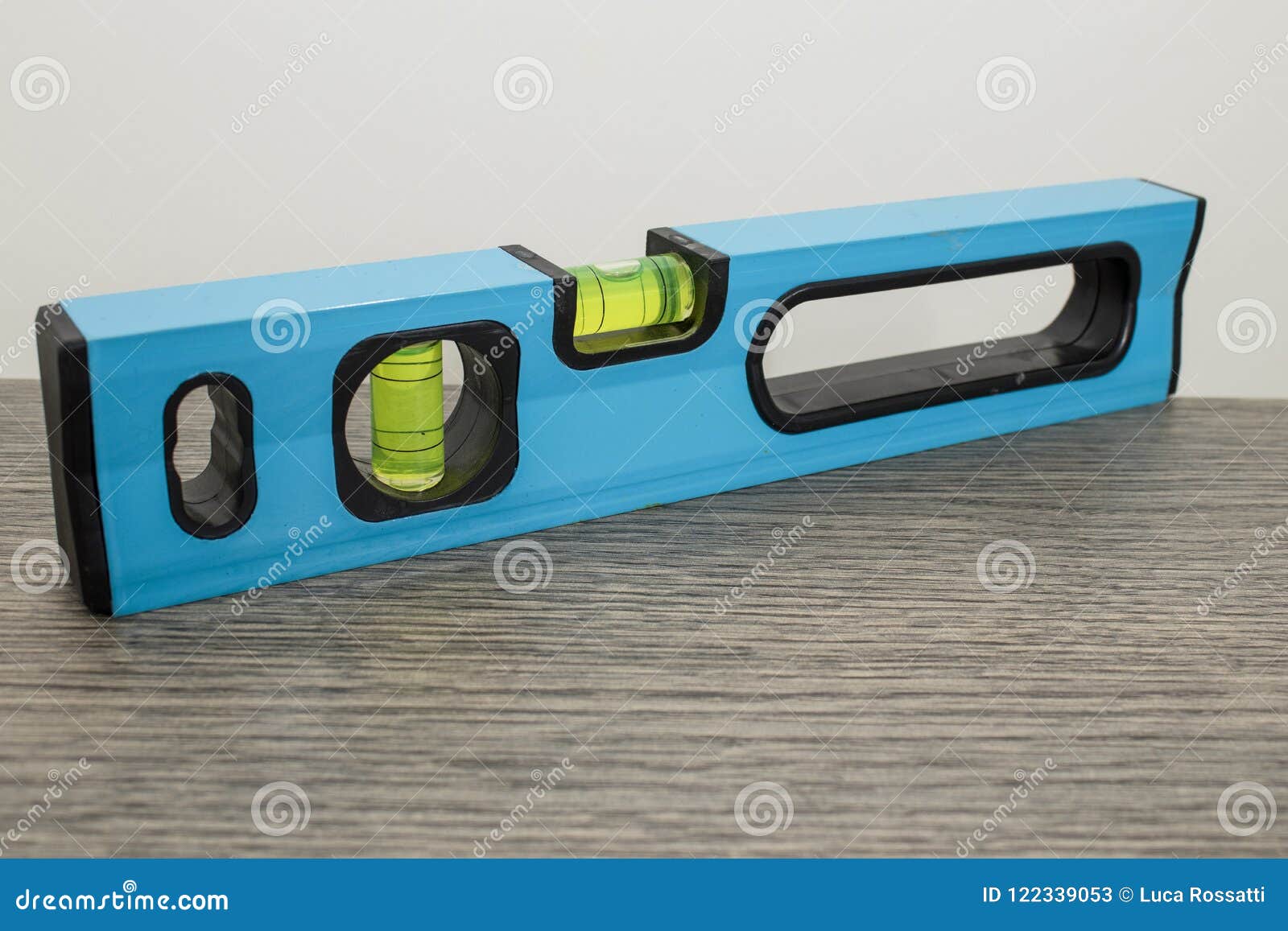 Tools, Blue Bubble Level on a Decorated Wood Table Stock Image - Image ...