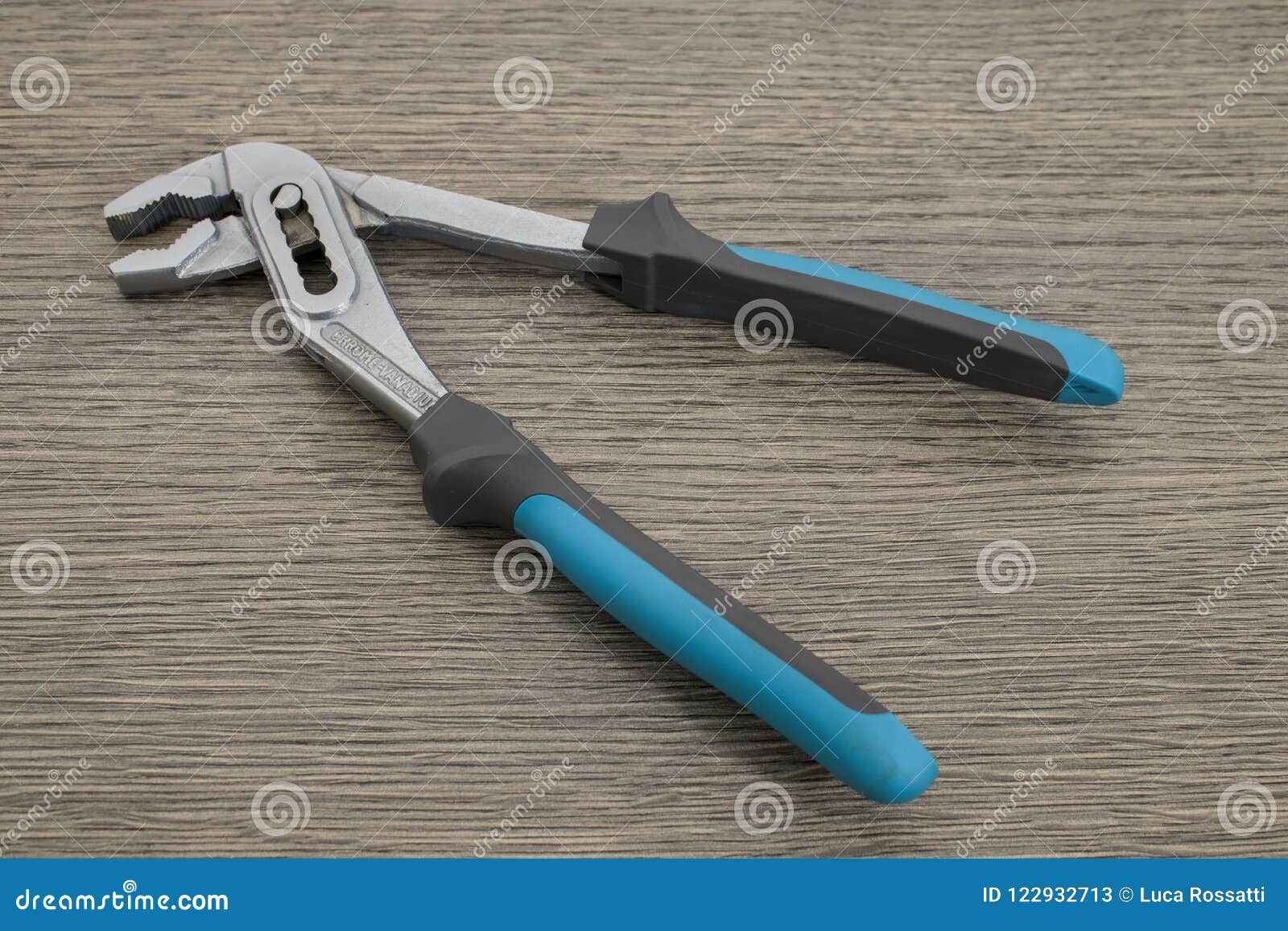 Tools, Blue Pipe Wrench on a Decorated Wood Table Stock Image - Image ...