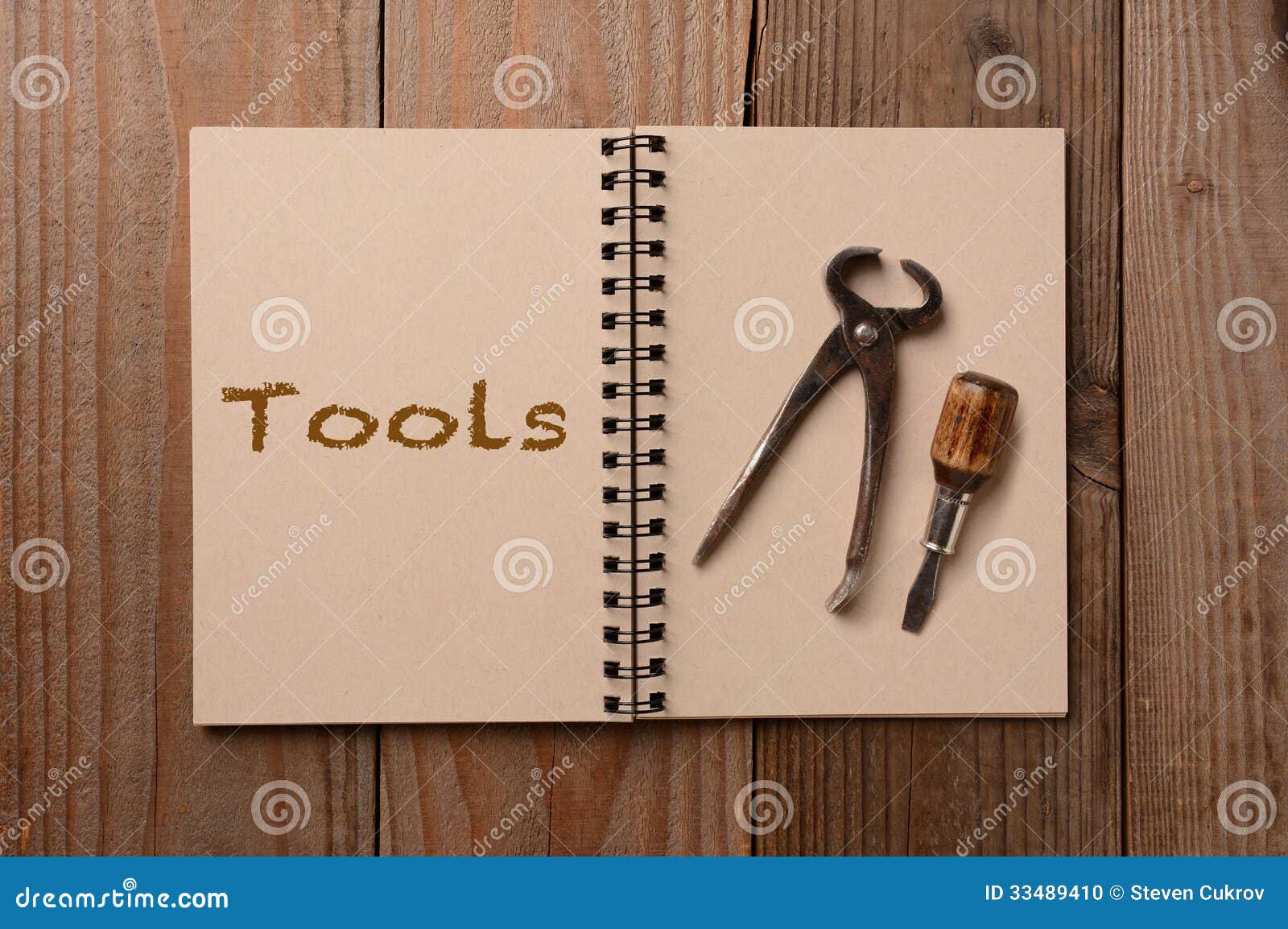 Tools on an Open Notebook stock photo. Image of wood - 33489410