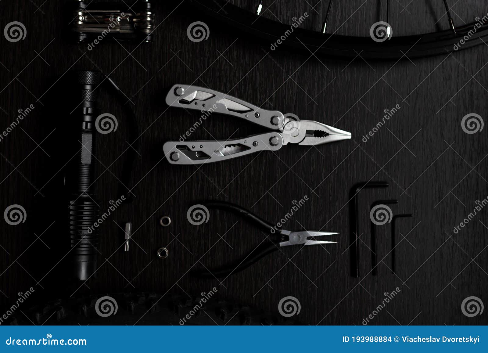 Tools on the Table. Spoked Wheel, Tire, Hex Keys, Brake Disc, Multitool ...