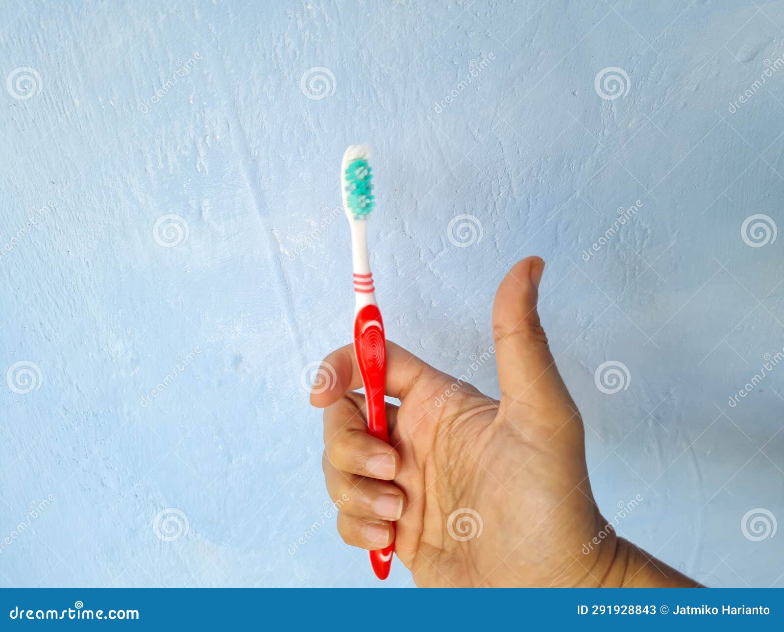 Toothbrush with a Combination of Red, White and Green on a Blue ...