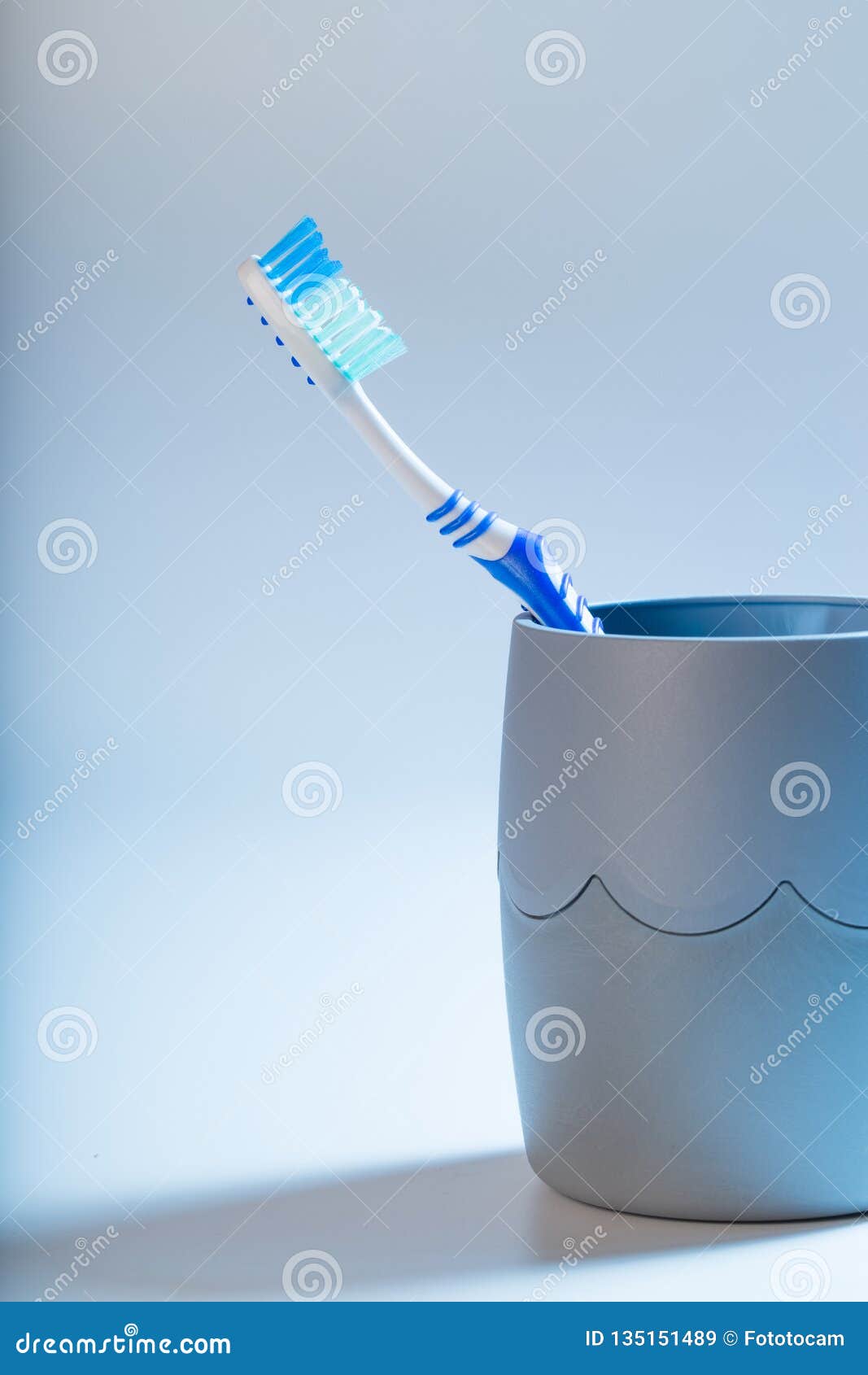 A Toothbrush in a Cup on Blue Background Stock Image - Image of hygiene ...