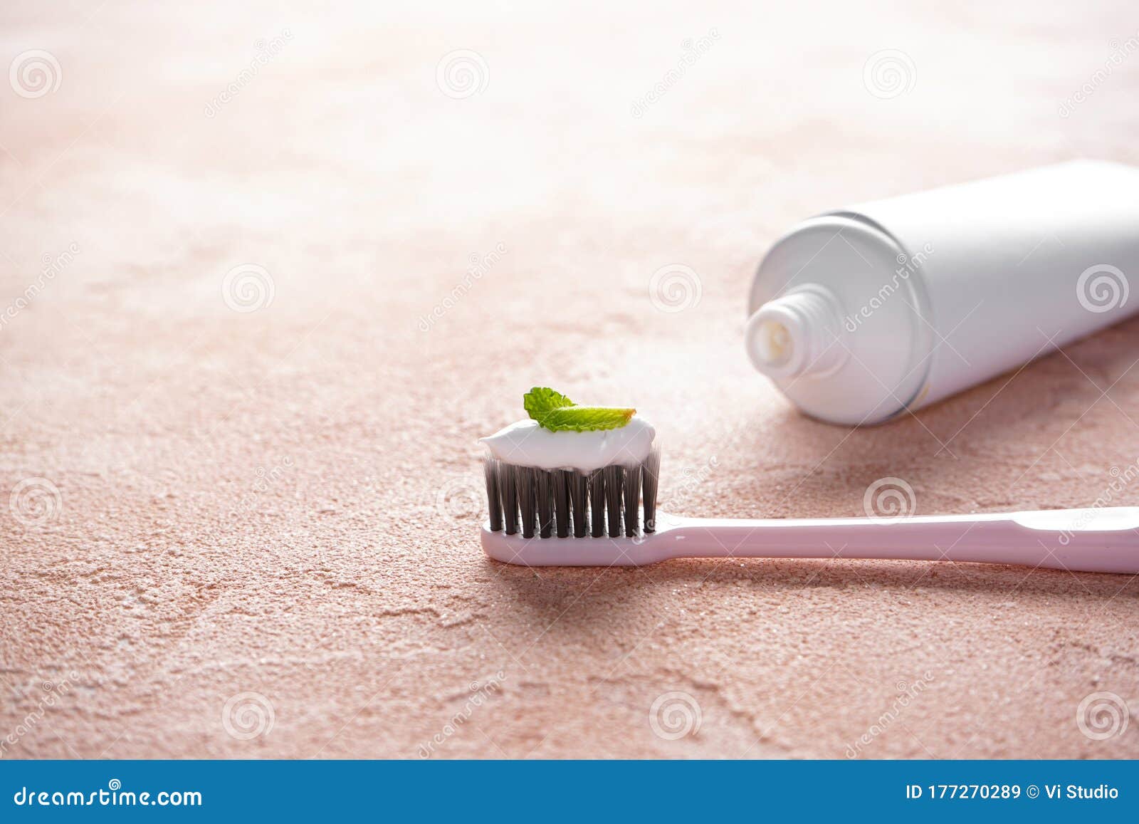 Toothbrush with Toothpaste on a Beige Background with a Leaf of Mint ...