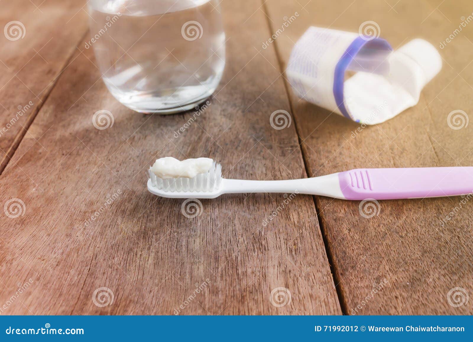 Toothbrush With Toothpaste On Blurred Glass Of Water Background Royalty ...