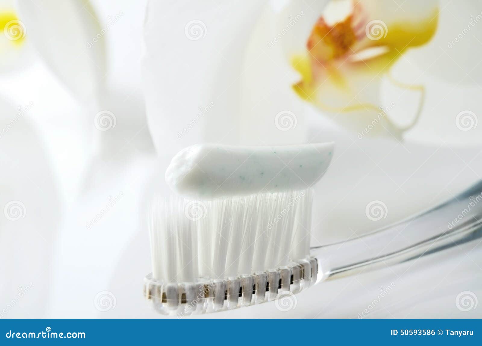 Toothbrush with Toothpaste on a White Table Against the Background of ...