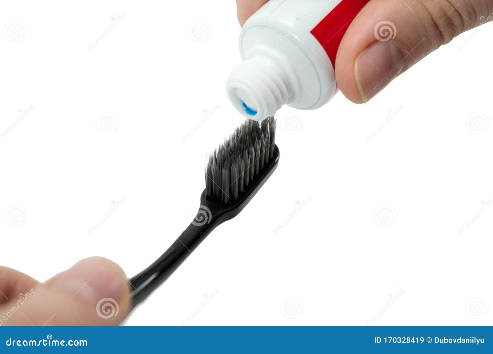 A Toothbrush and Tube of Toothpaste in a Hand Isolated on White ...