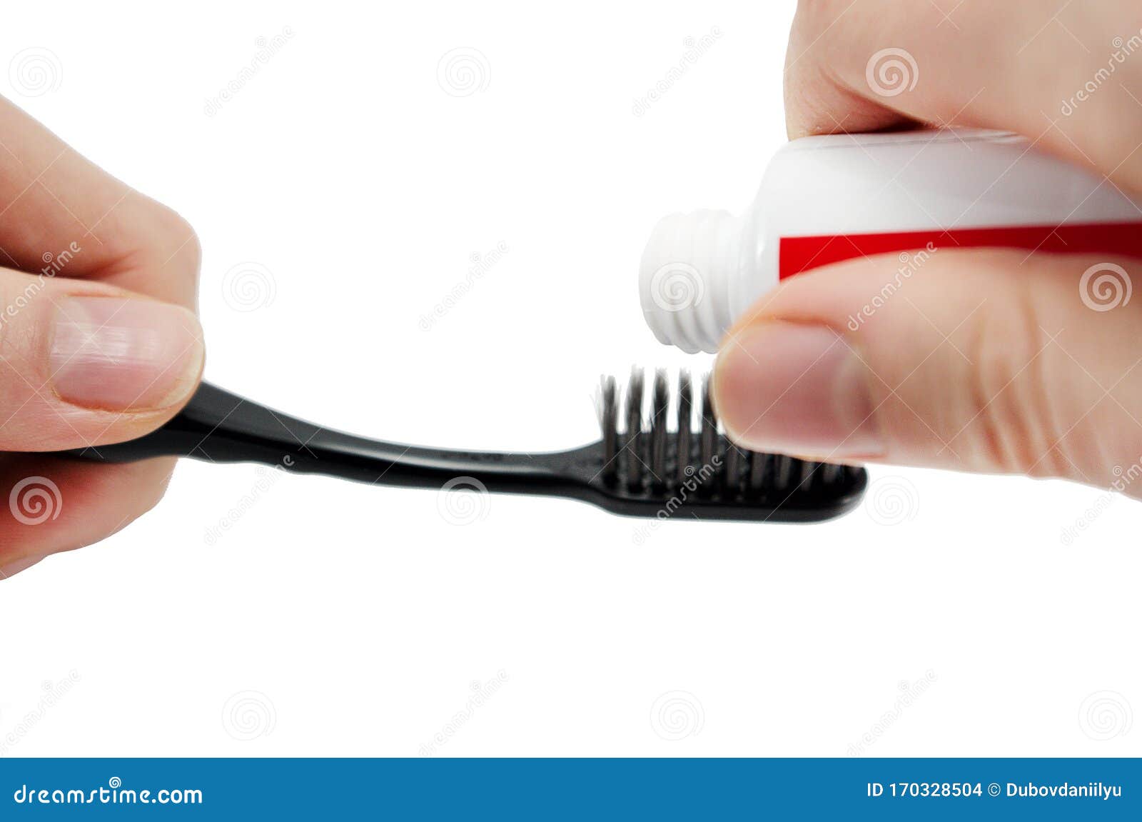 A Toothbrush and Tube of Toothpaste in a Hand Isolated on White ...