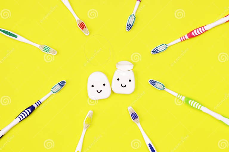 Toothbrushes and Dental Floss on Yellow Background Stock Photo - Image ... Toothbrushes and Dental Floss on Yellow Background Stock Photo - Image ...