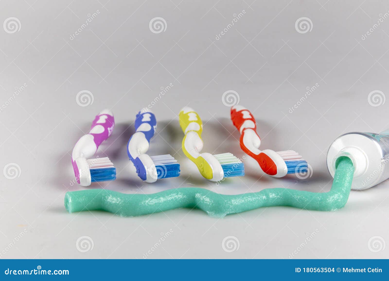 Green Toothpaste and Multicolored Toothbrushes To a Tube of Toothpaste ...