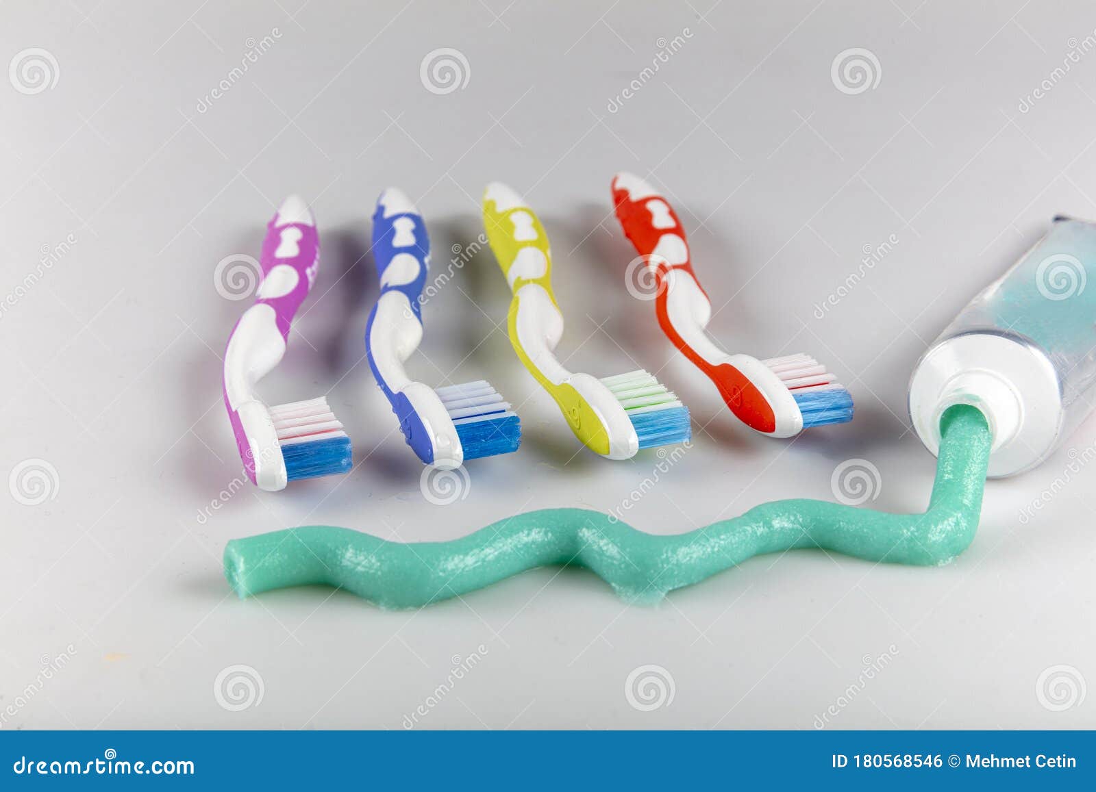Green Toothpaste and Multicolored Toothbrushes To a Tube of Toothpaste ...
