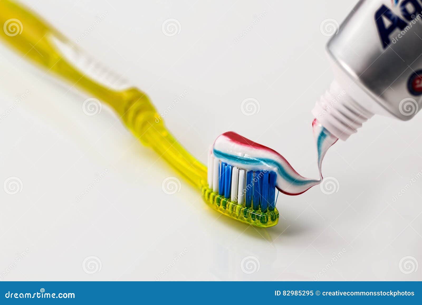 Toothpaste Being Put On Yellow Toothbrush Picture. Image: 82985295