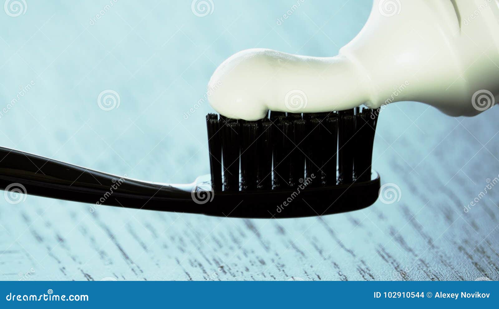 Toothpaste Being Squeezed Onto the Black Toothbrush Stock Photo - Image ...