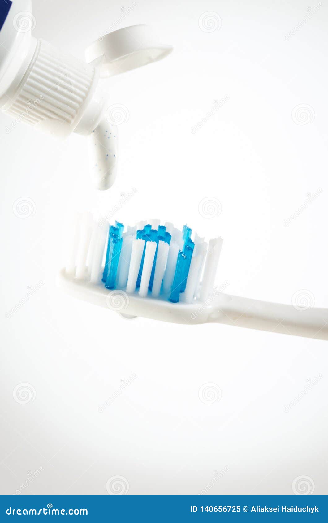 Toothpaste Squeezed from Tube Onto Brush on a White Background, Close ...