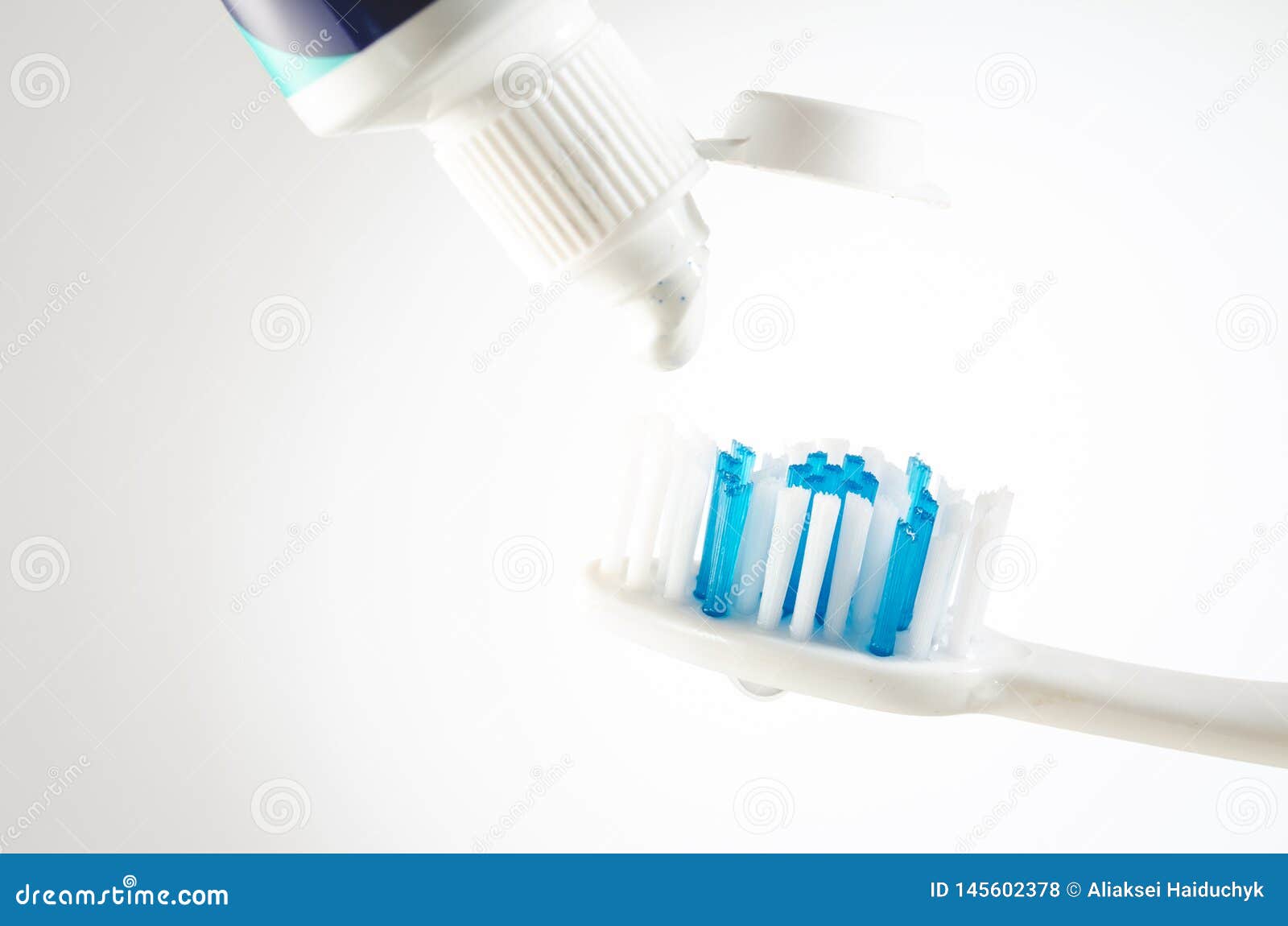 Toothpaste Squeezed from Tube Onto Brush on a White Background, Close ...