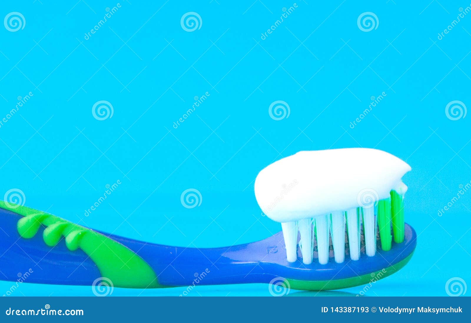 Toothpaste on a Toothbrush Close-up on a Blue Light Background Stock ...