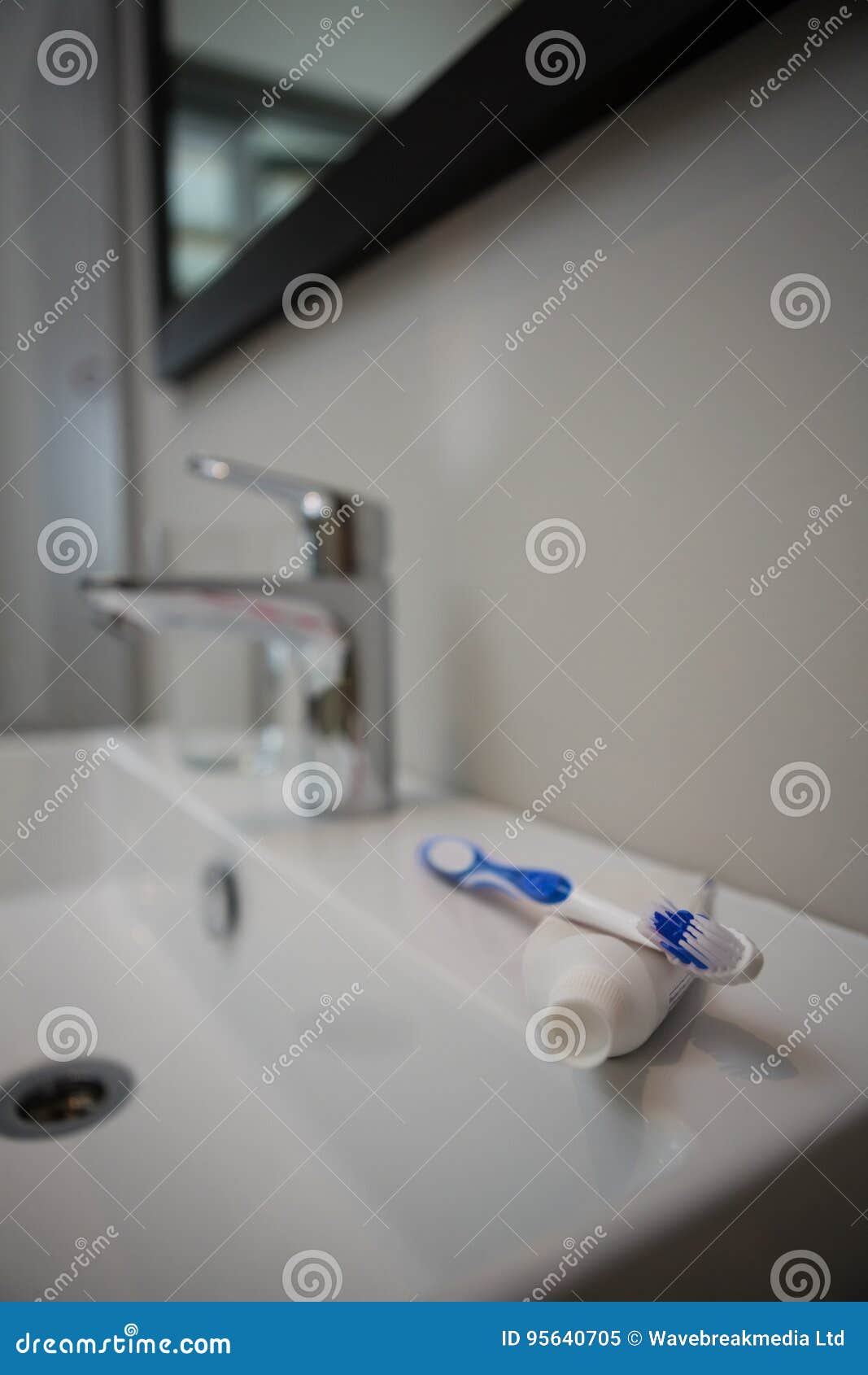 Toothpaste Tube and Toothbrush on a Bathroom Sink Stock Image - Image ...
