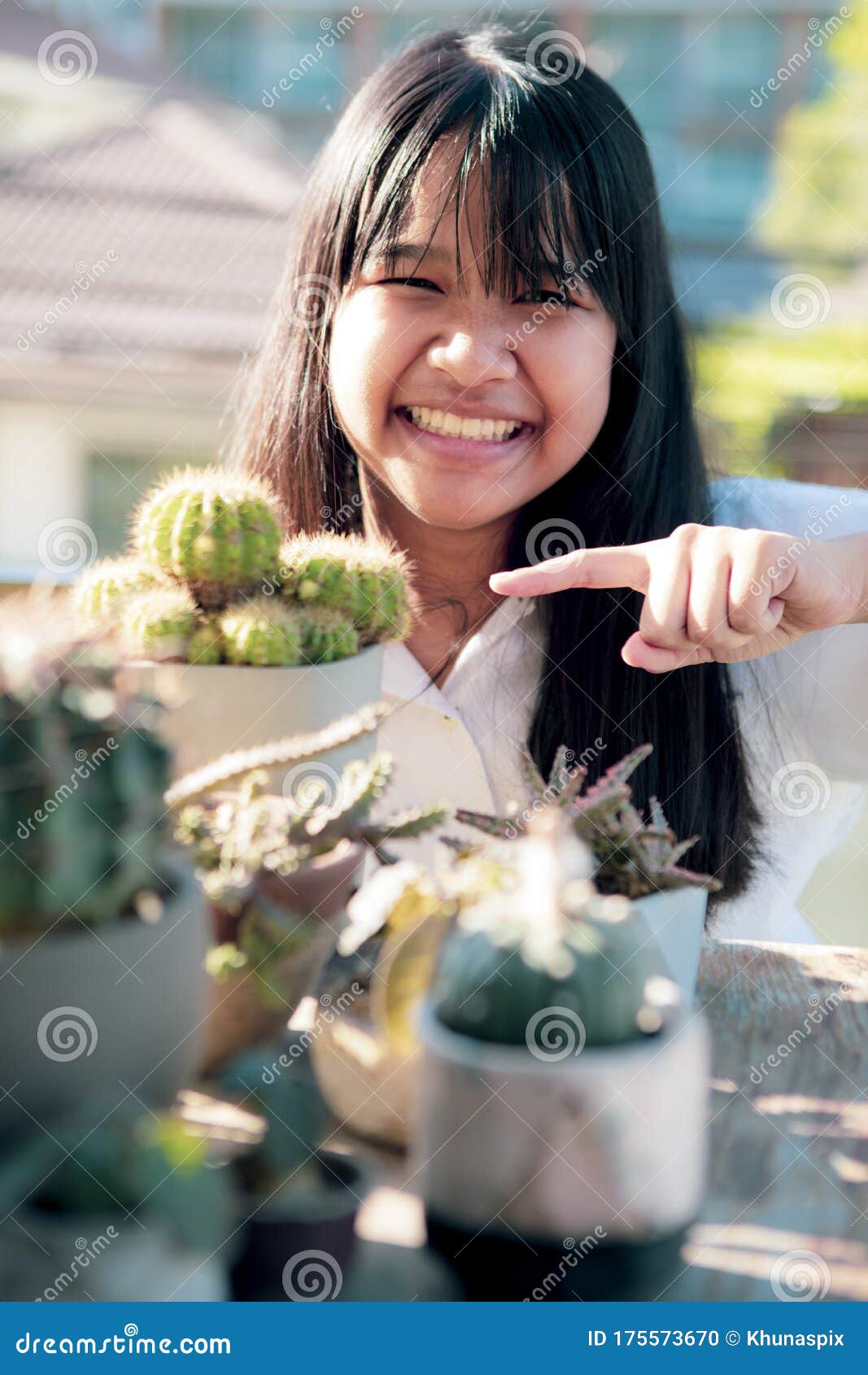 Toothy Smiling Face of Asian Teenager and Cactus Pot in Hand Stock ... Toothy Smiling Face of Asian Teenager and Cactus Pot in Hand Stock ...