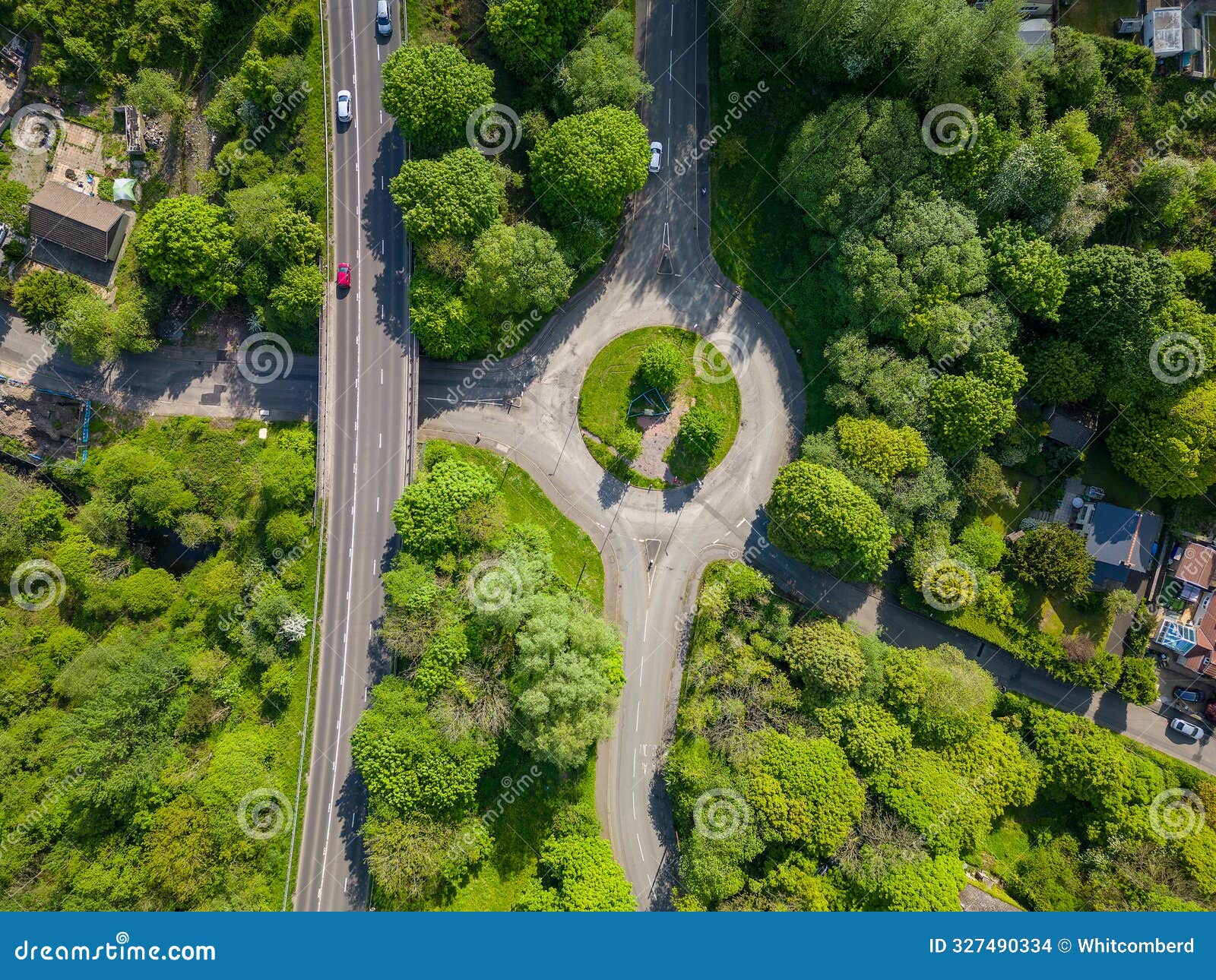Top Down Aerial View of a Small Roundabout Surrounded by Lush Foliage ...