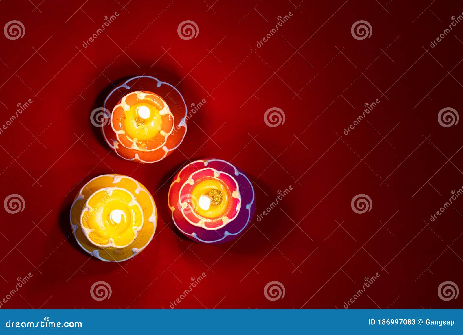 Top Down View of Earthen Lamps Burning Against Red Background Stock ...