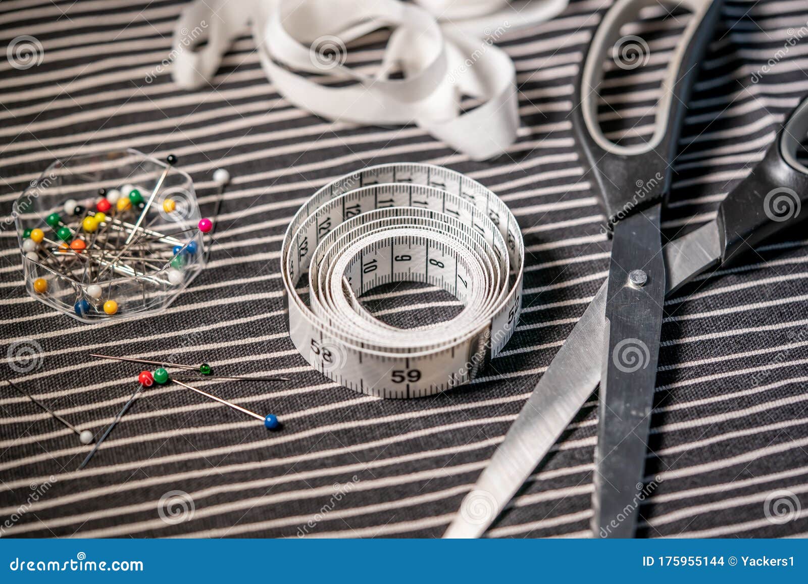 Tape Measure, Pins and Scissors on a Background of Stripey Material ...