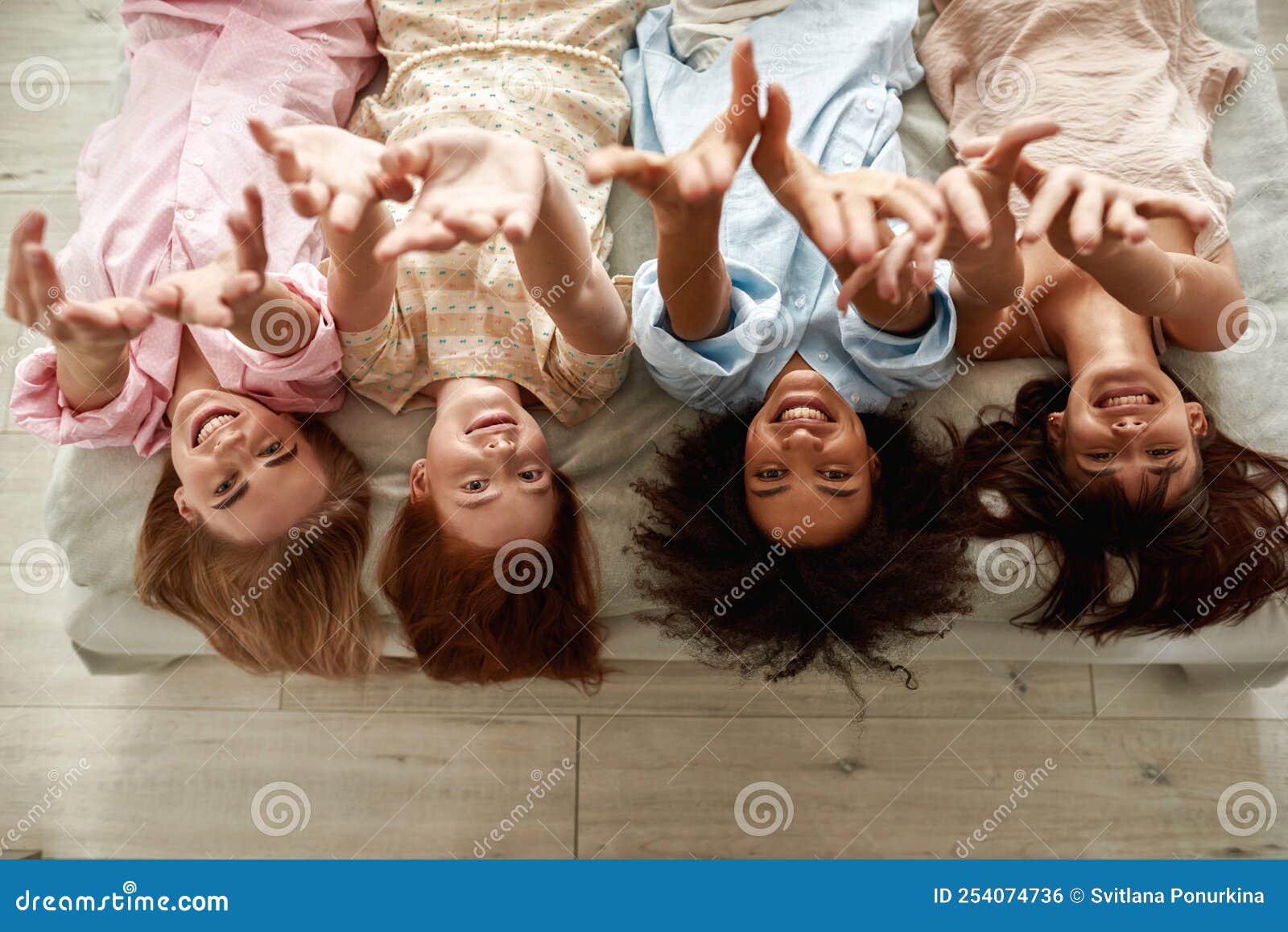Top of Girlfriends Lay on Bed and Pull Hands Up Stock Photo - Image of ...
