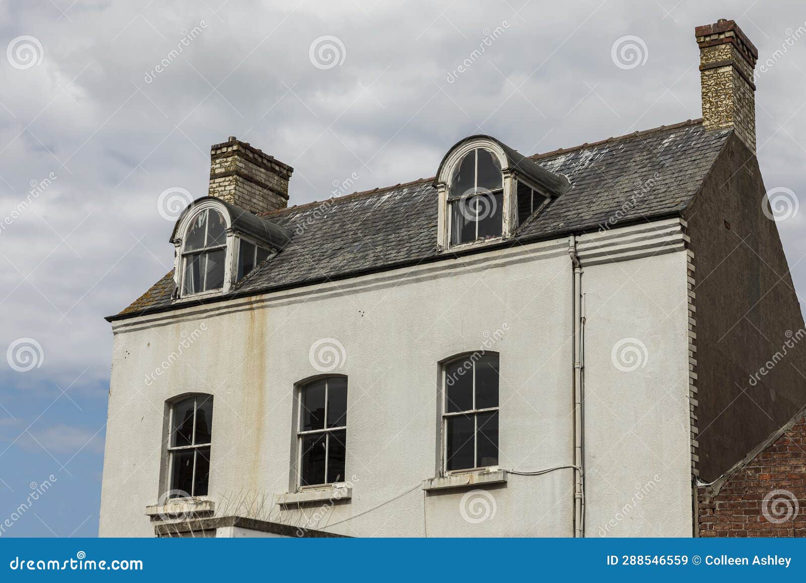 The Top Half of a White Building with Arched Attic Windows Stock Image ...